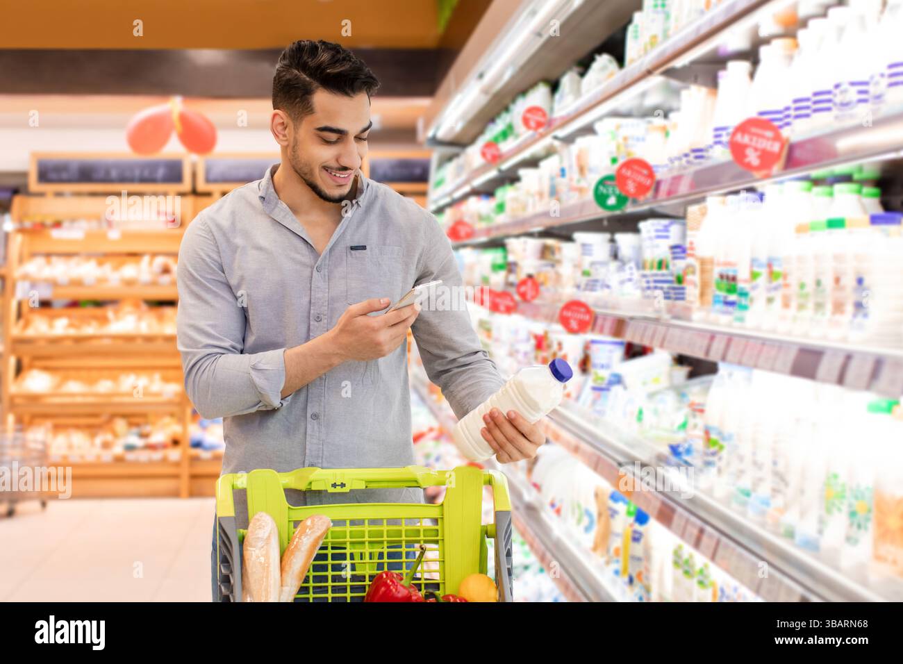 Arabic Guy Scanning Milk Bottle Using Phone Application During Grocery ...