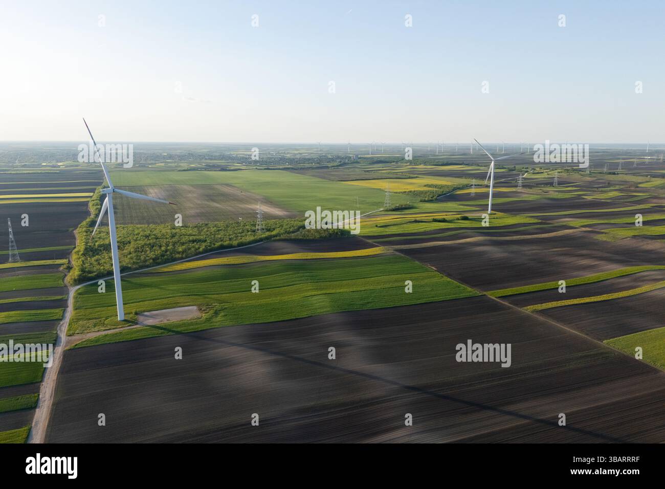 Aerial view of wind turbines on an agricultural field. Sustainable ...