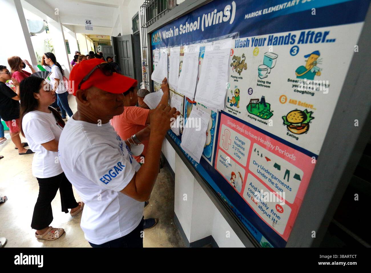Philippines. 12th May, 2025. Voters check their name on voter's ...