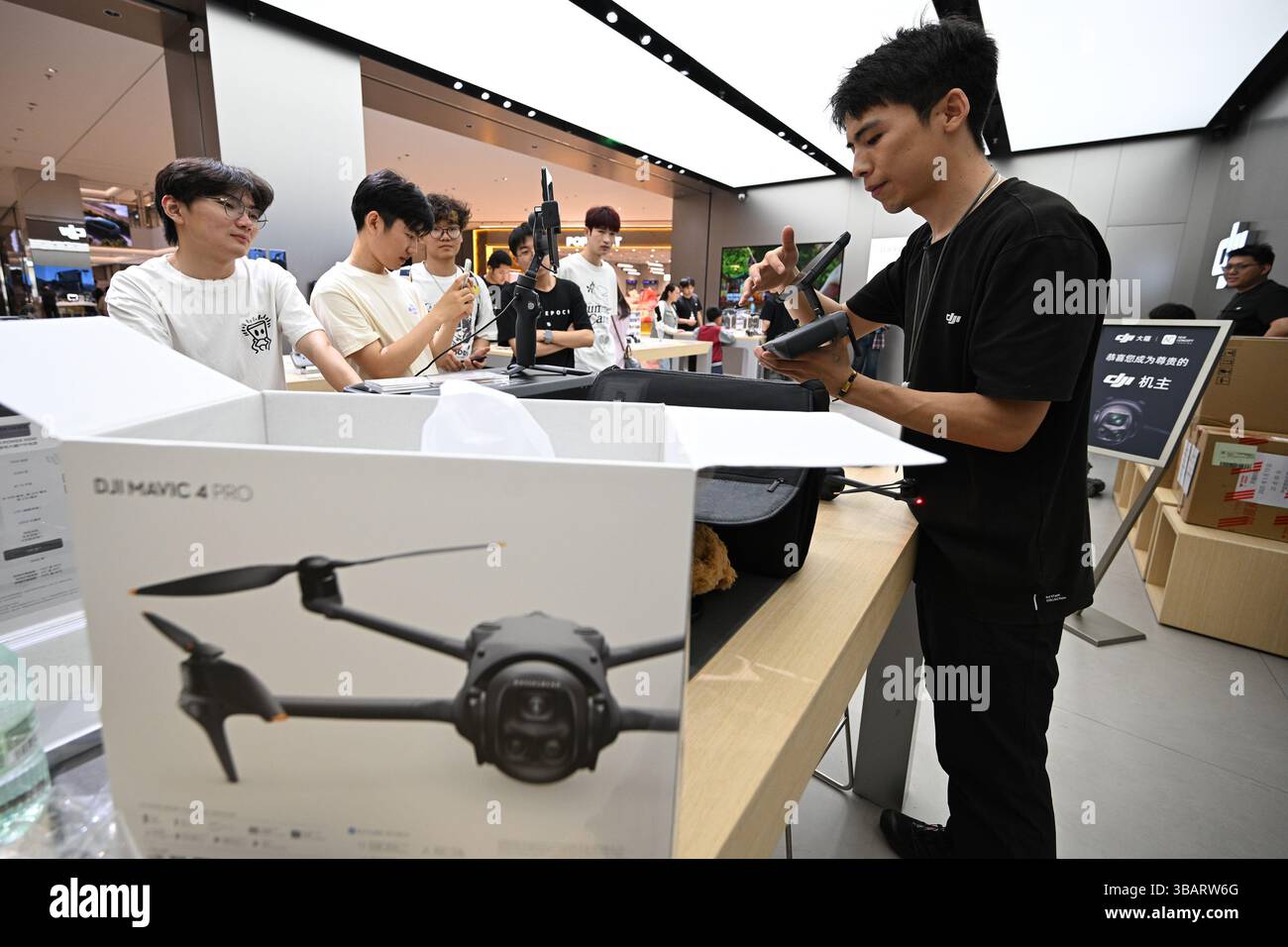 NANJING, CHINA - MAY 13, 2025 - A staff member at a DJI store showcases ...