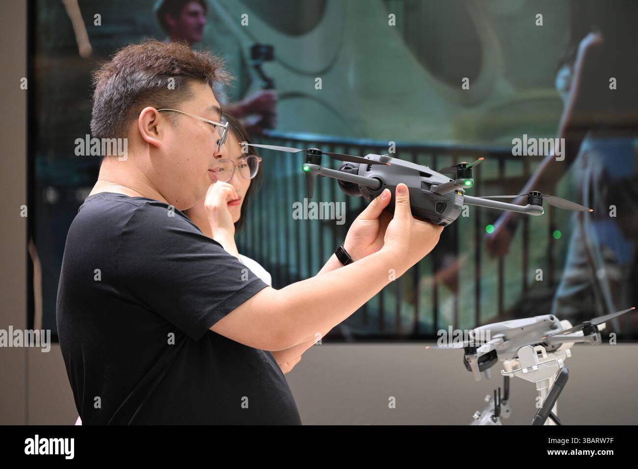 NANJING, CHINA - MAY 13, 2025 - A customer is watching the newly ...