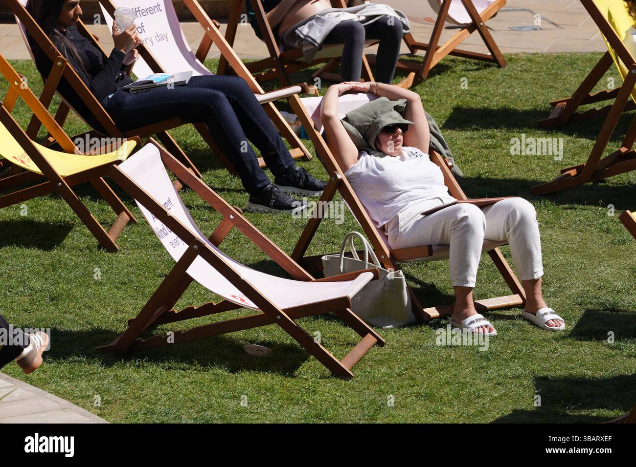 People enjoying the spring sunshine in Paddington, London. Picture date ...