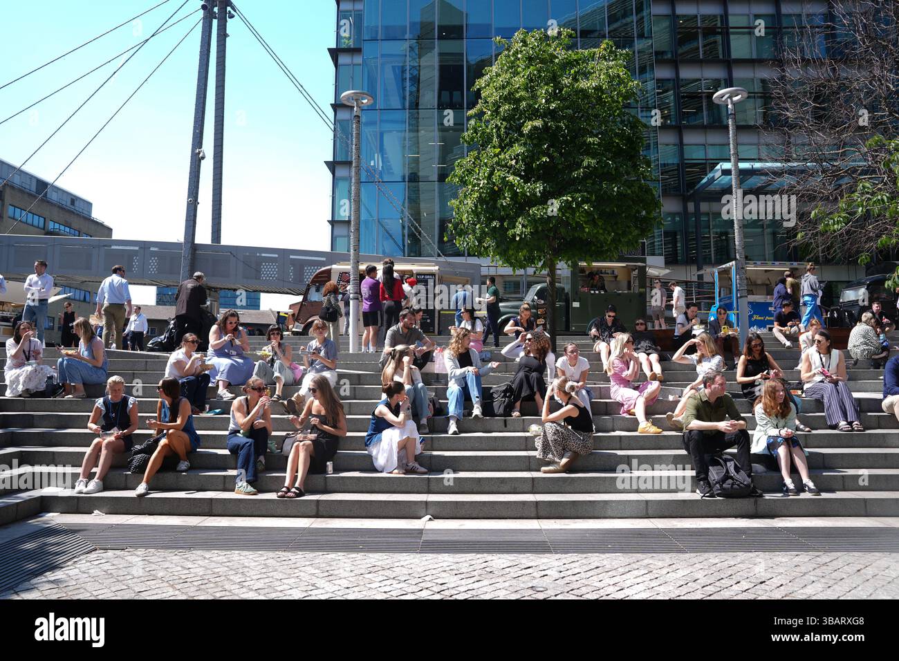 People enjoying the spring sunshine in Paddington, London. Picture date ...