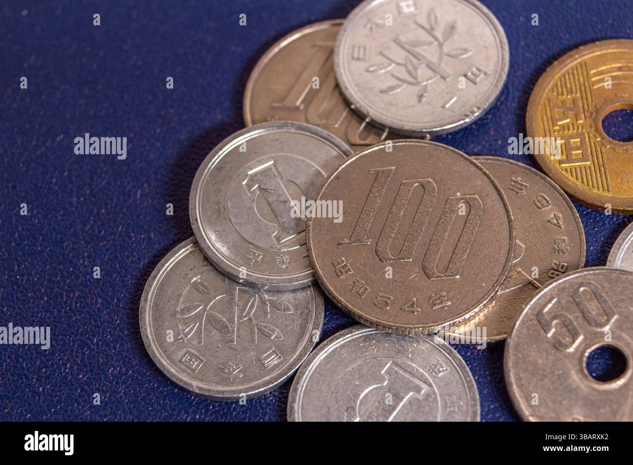 A detailed close-up of various Japanese yen coins, including 1, 5, 50 ...