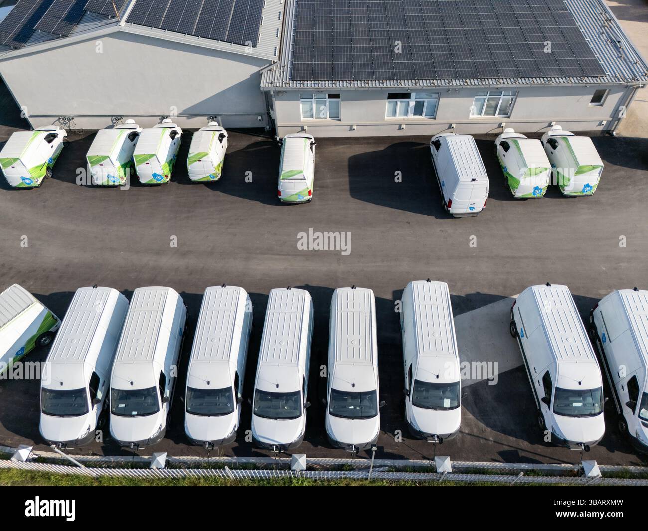 Electric delivery vans hub. Fleet of electric vehicles Stock Photo - Alamy