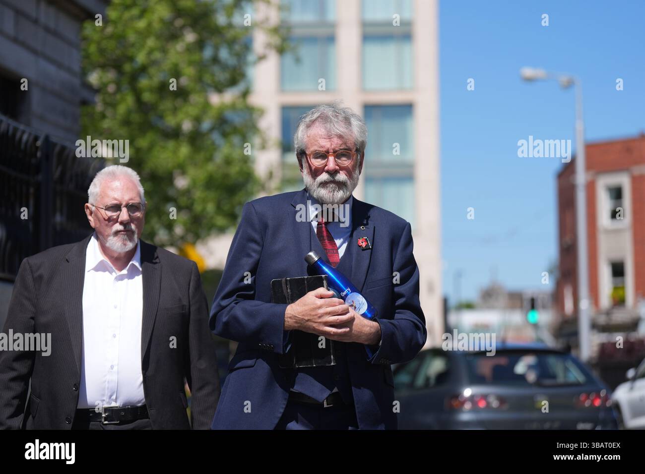 Former Sinn Fein press officer Richard McAuley (left) walks with former ...