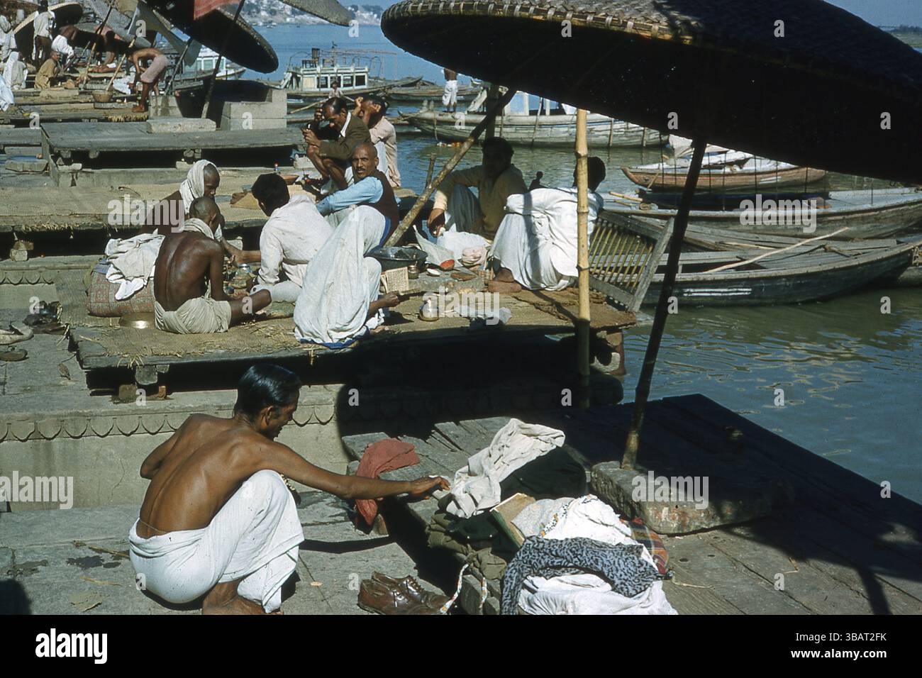 1960s, historical, people beside the ganges river gathered to pray and ...