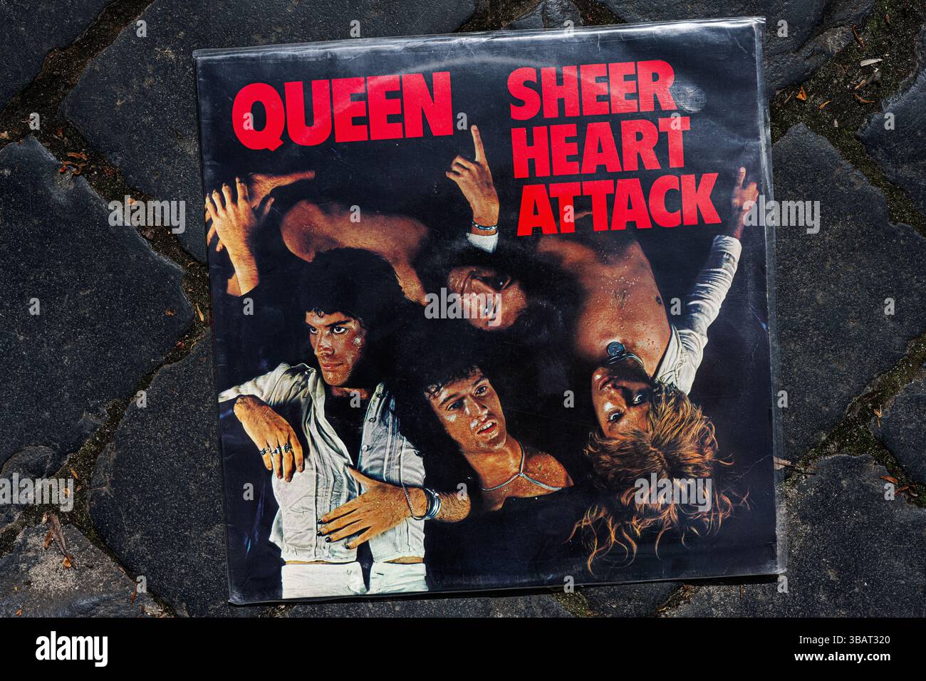 Lviv, Ukraine - May 13, 2025: The 1974 Queen album cover Sheer Heart Attack shown on textured ...