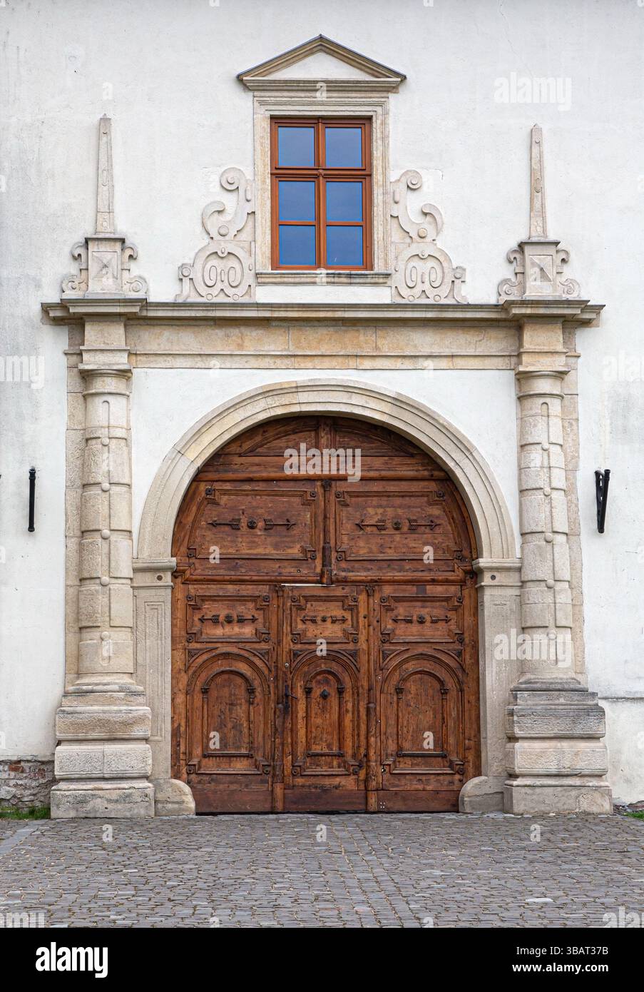Old ornate wooden door with stone arch and window, showcasing ...