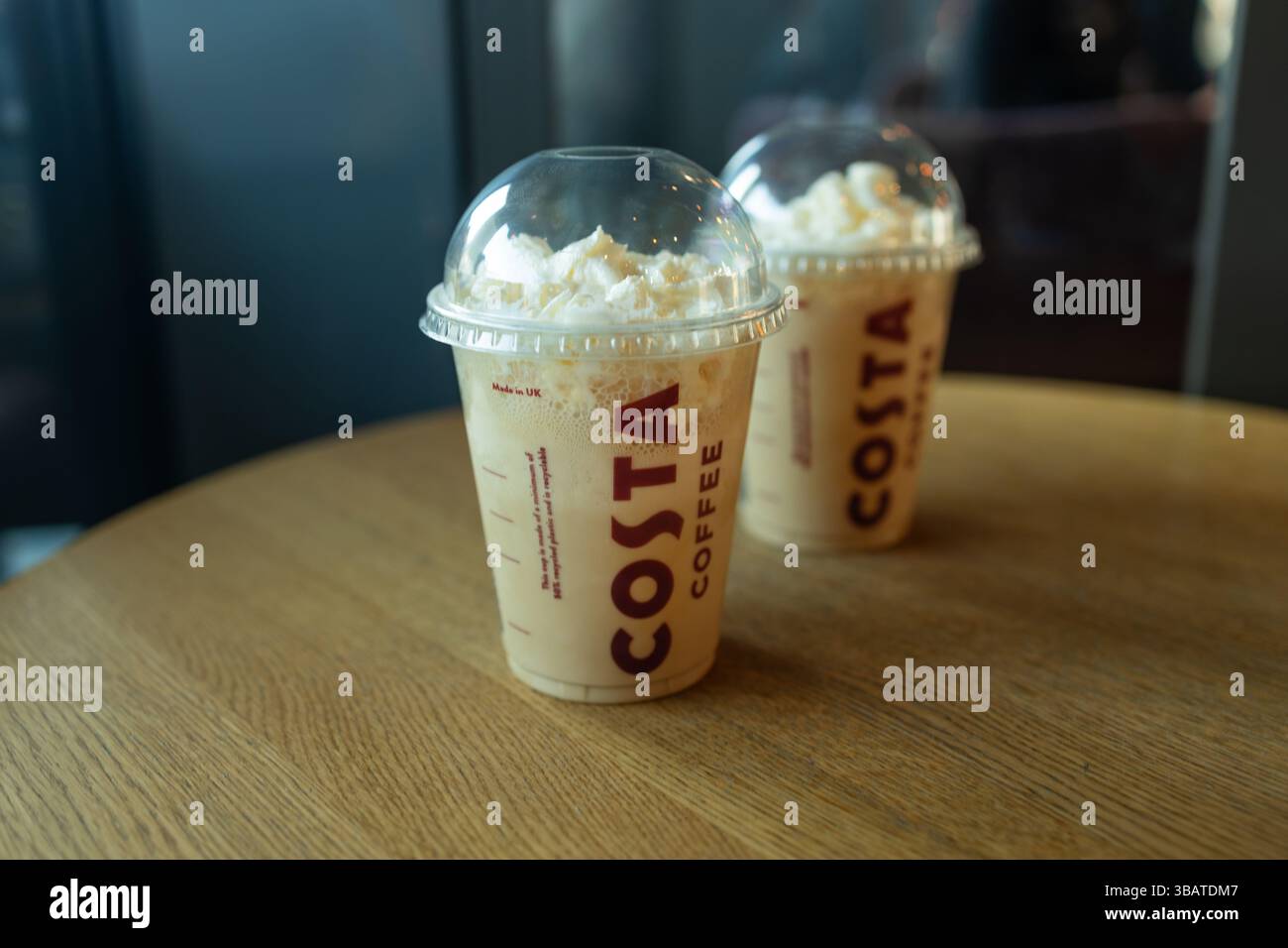 Iced coffee with cream in Costa cups on table Stock Photo - Alamy