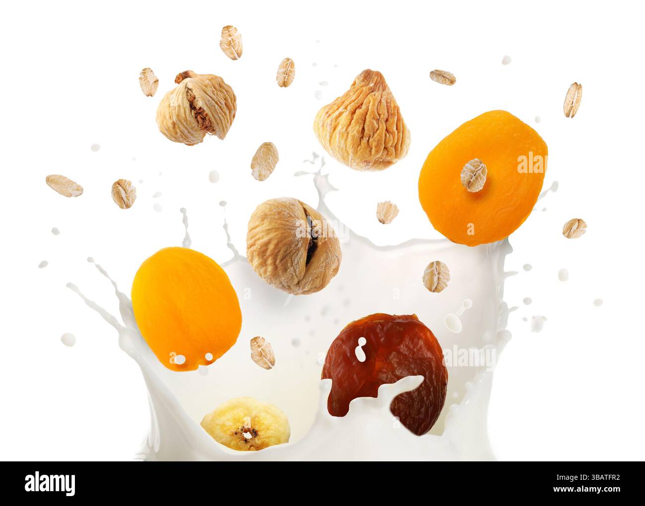 Milk splash with oat flakes and dried fruits in air on white background ...