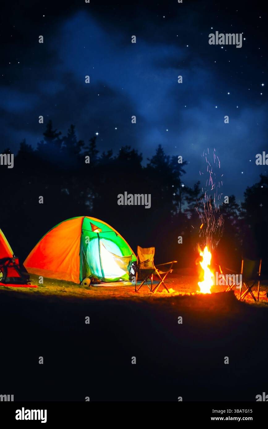 Camping tents and bonfire in wilderness at night under starry sky Stock ...