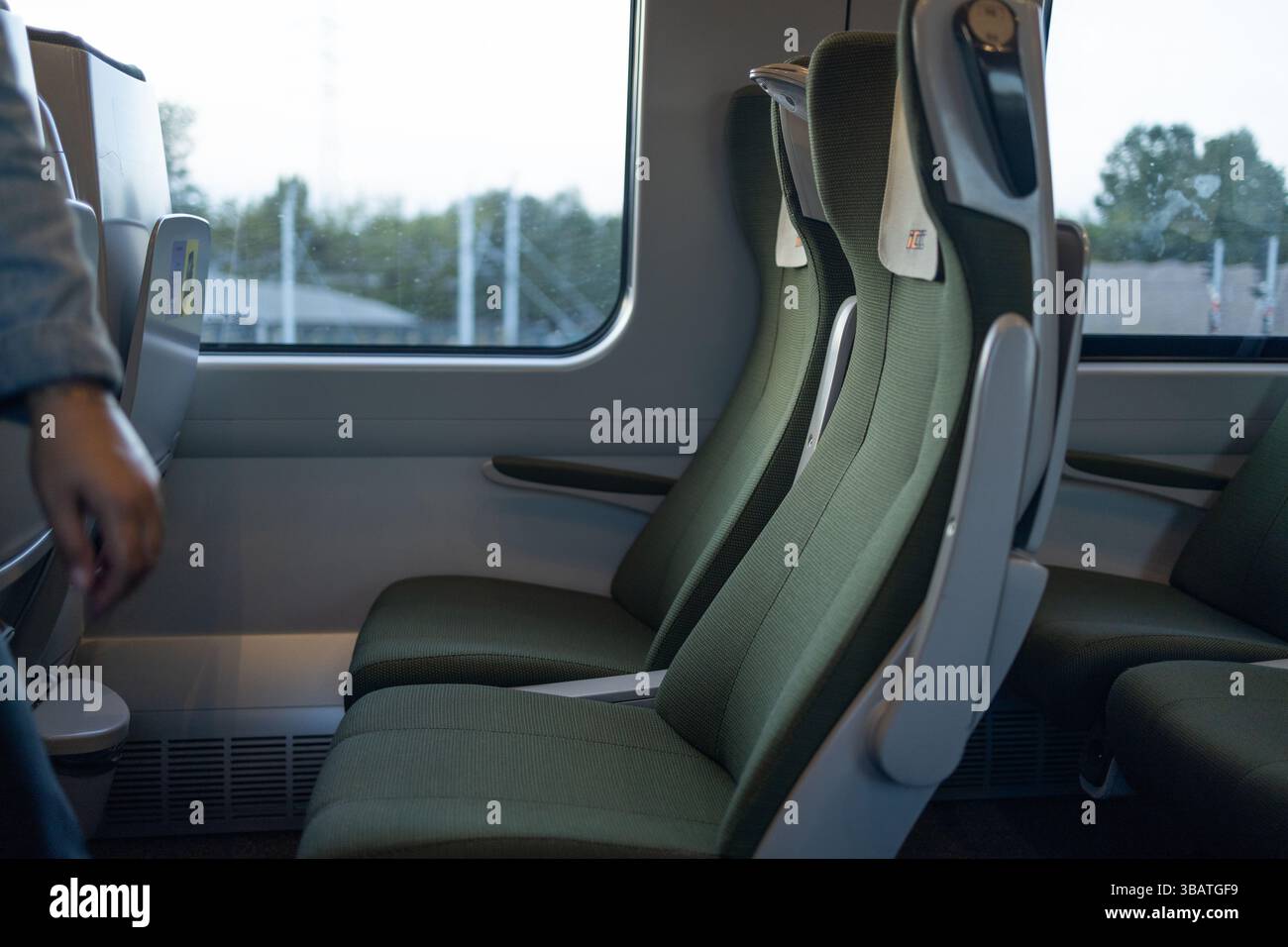 Empty train seats with passenger entering, Gdansk Stock Photo - Alamy