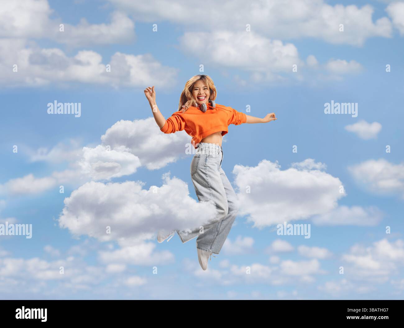 Overjoyed asian woman jumping up in the sky Stock Photo - Alamy