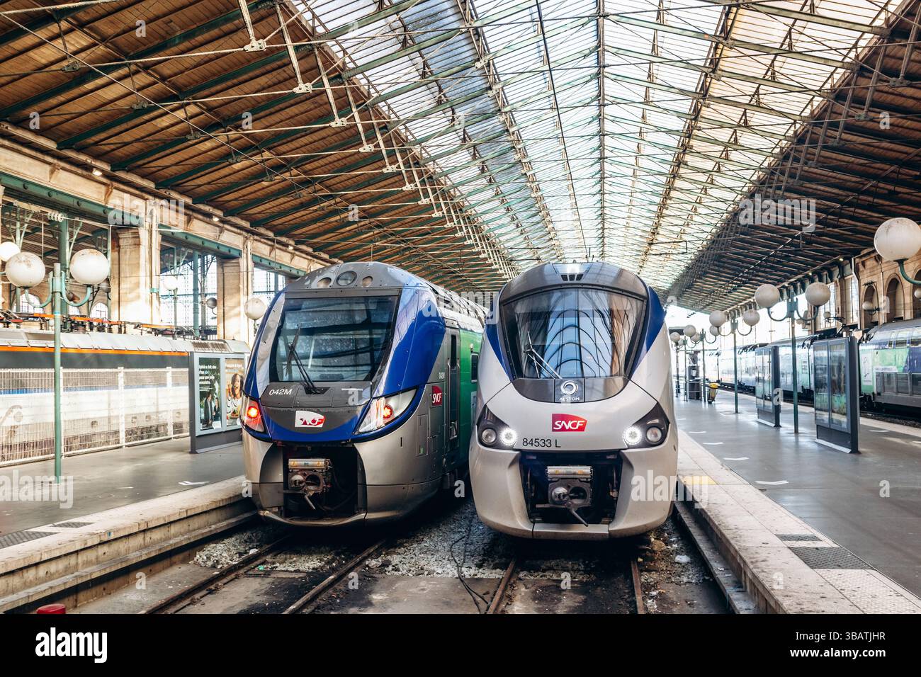 Paris, France - Modern SNCF trains at Gare du Nord under historic glass ...