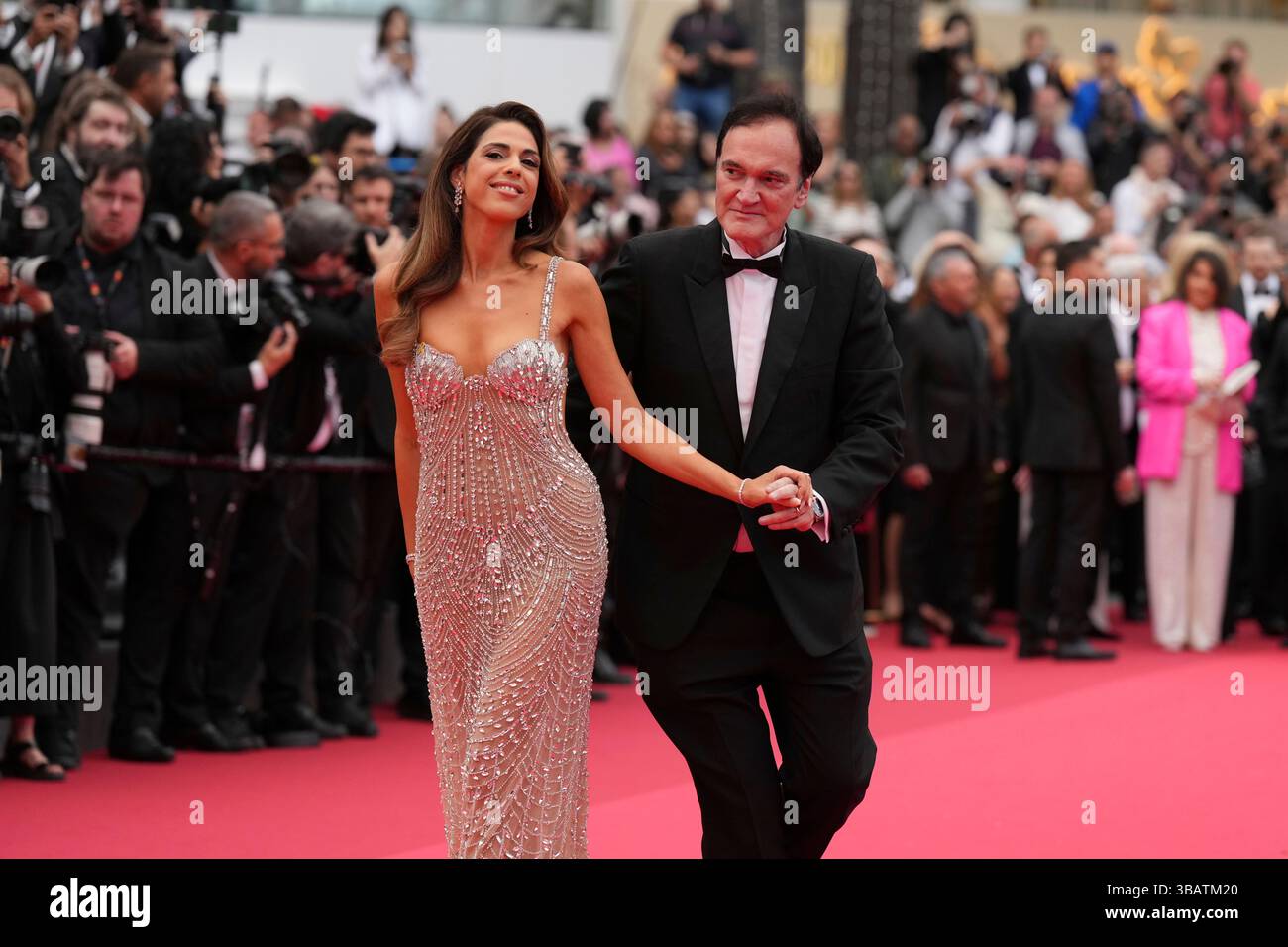 Daniella Pick, left, and Quentin Tarantino pose for photographers ...