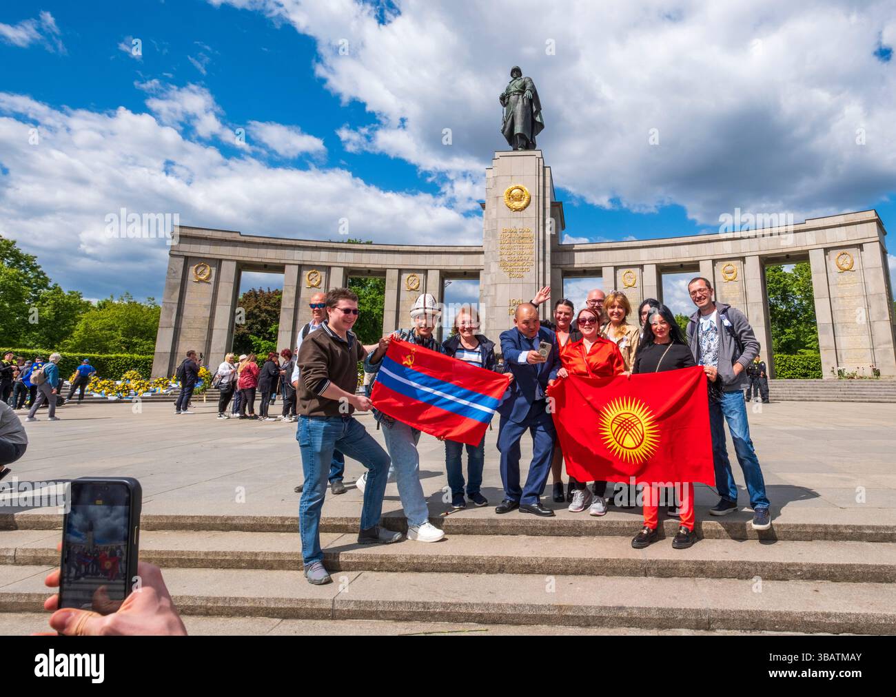People holding the flags of Kyrgyzstan and of the Kyrgyz Soviet Socialist Republic at the Soviet ...