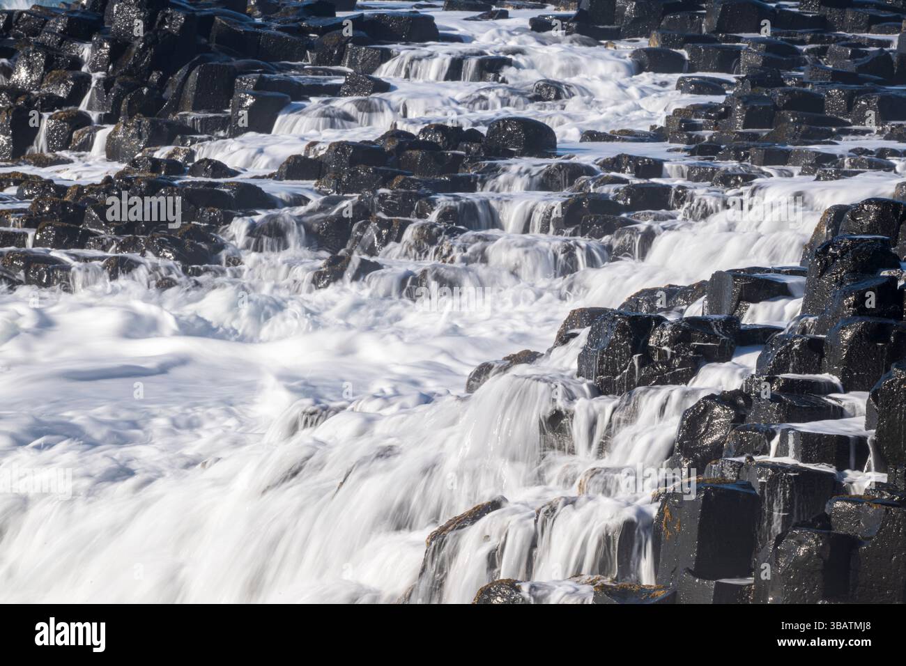 Close up of interlocking basalt columns of Grand Causeway, with sea ...