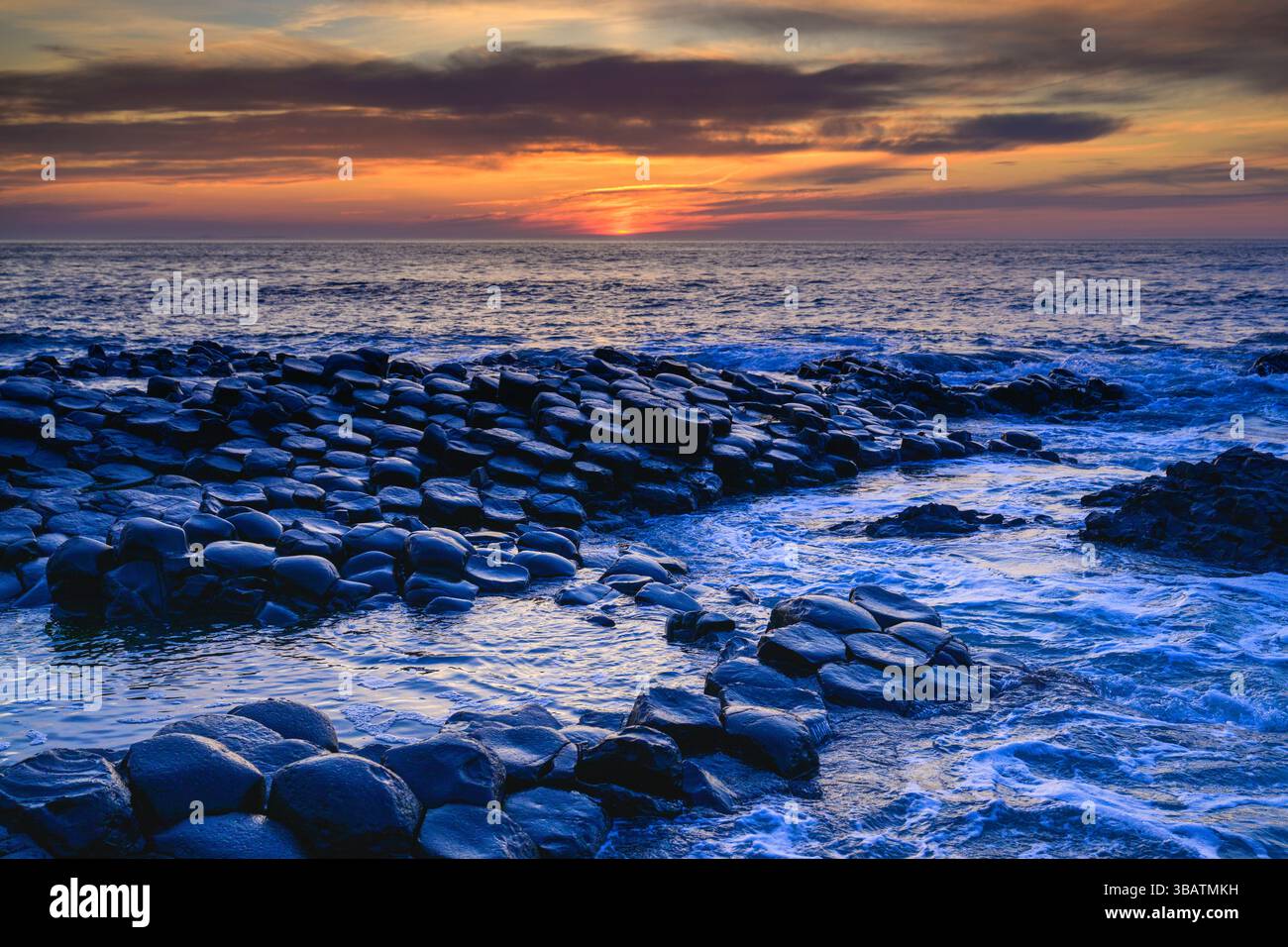Sun setting behind Little Causeway, part of the interlocking basalt ...