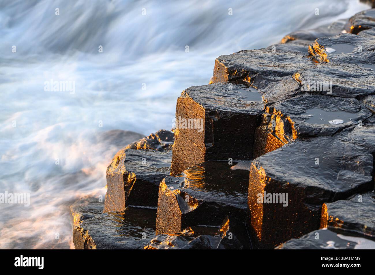 Late afternoon sunlight on close up of basalt columns of Middle ...