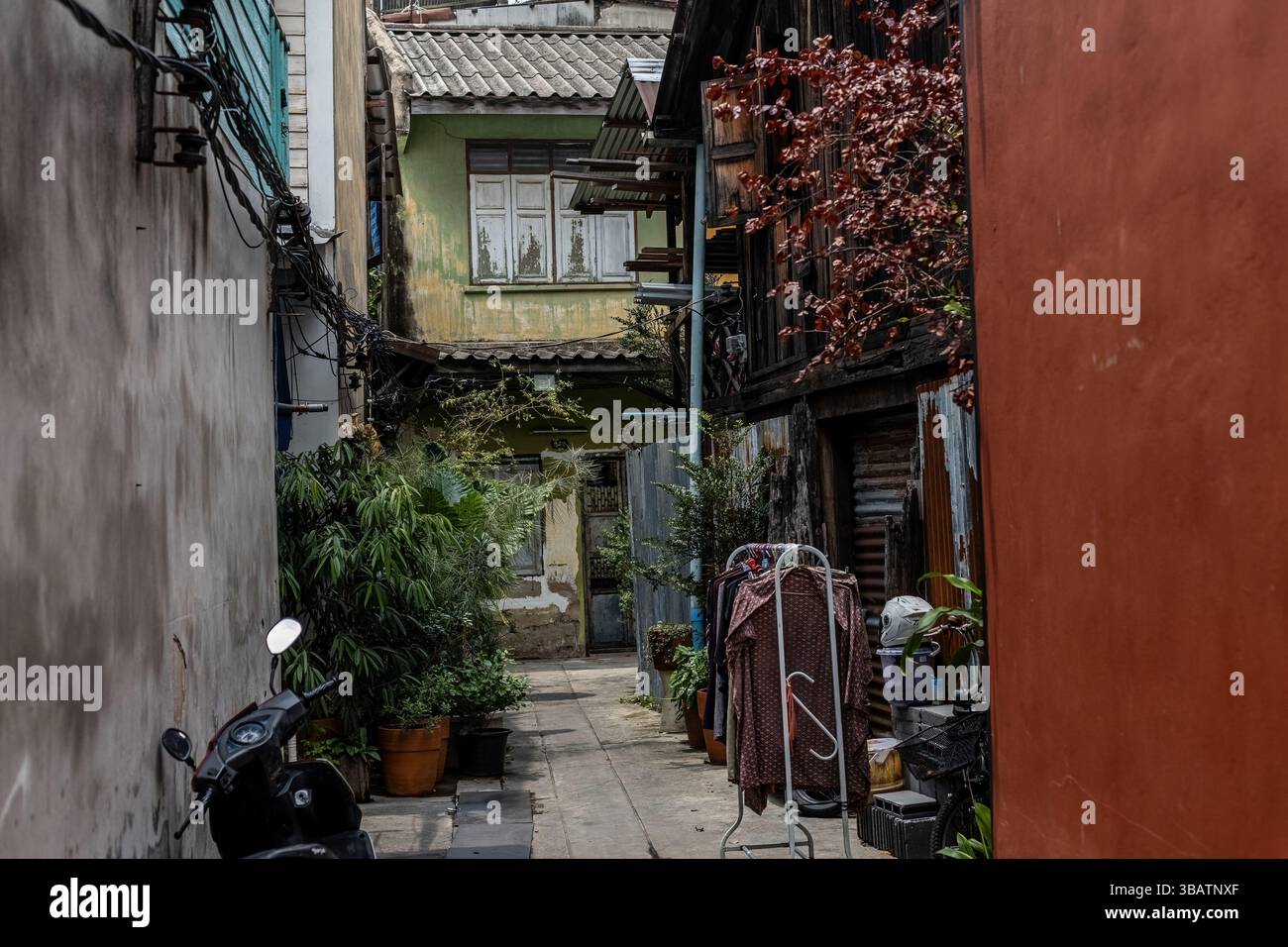 Street at Talat Noi area of Bangkok old houses and motorcycles parked ...