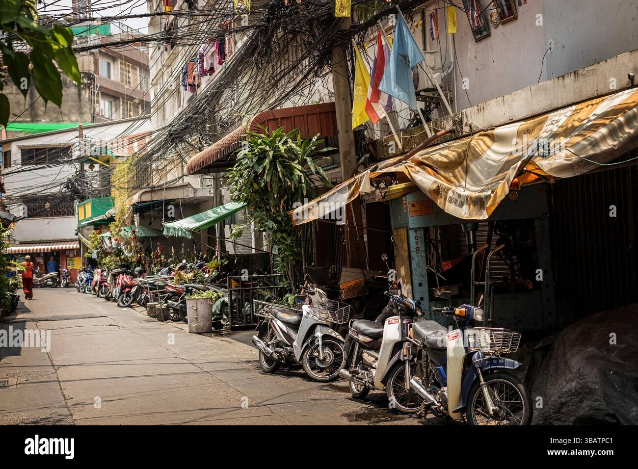 Bangkok street in Talat Noi area old houses and motorcycles parked ...