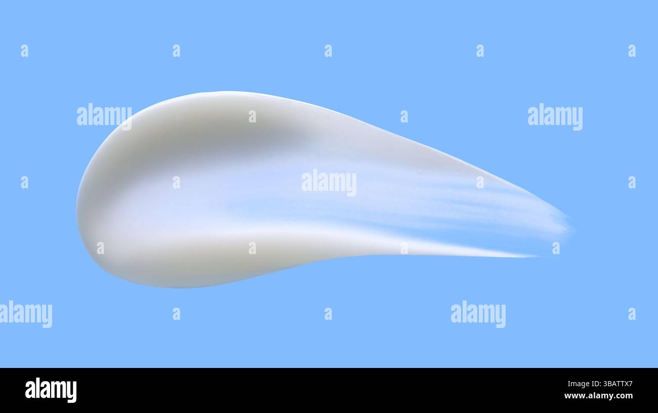 White cosmetic cream swipe stroke isolated on blue background. Cream ...