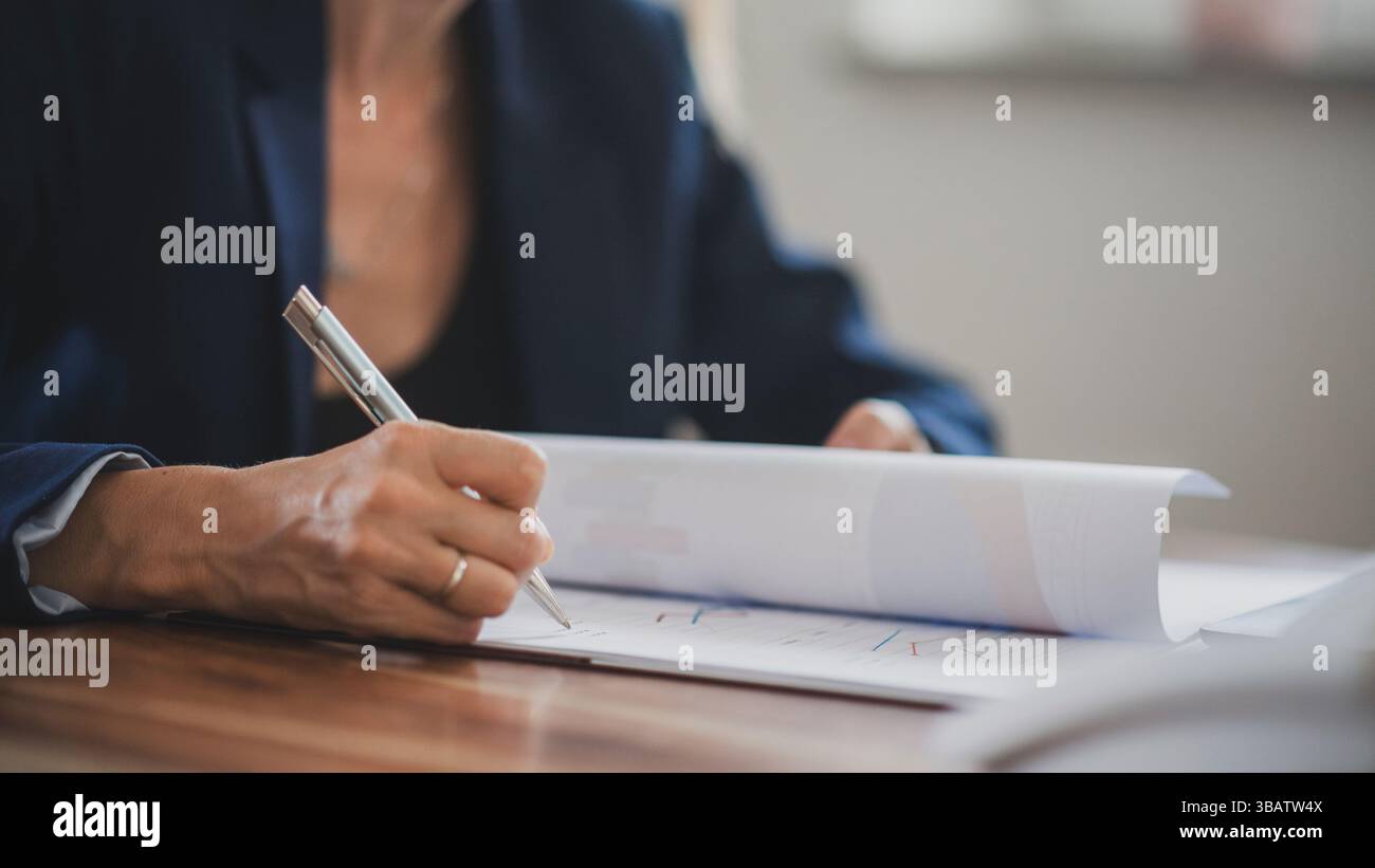 Reviewing charts woman taking notes hi-res stock photography and images ...