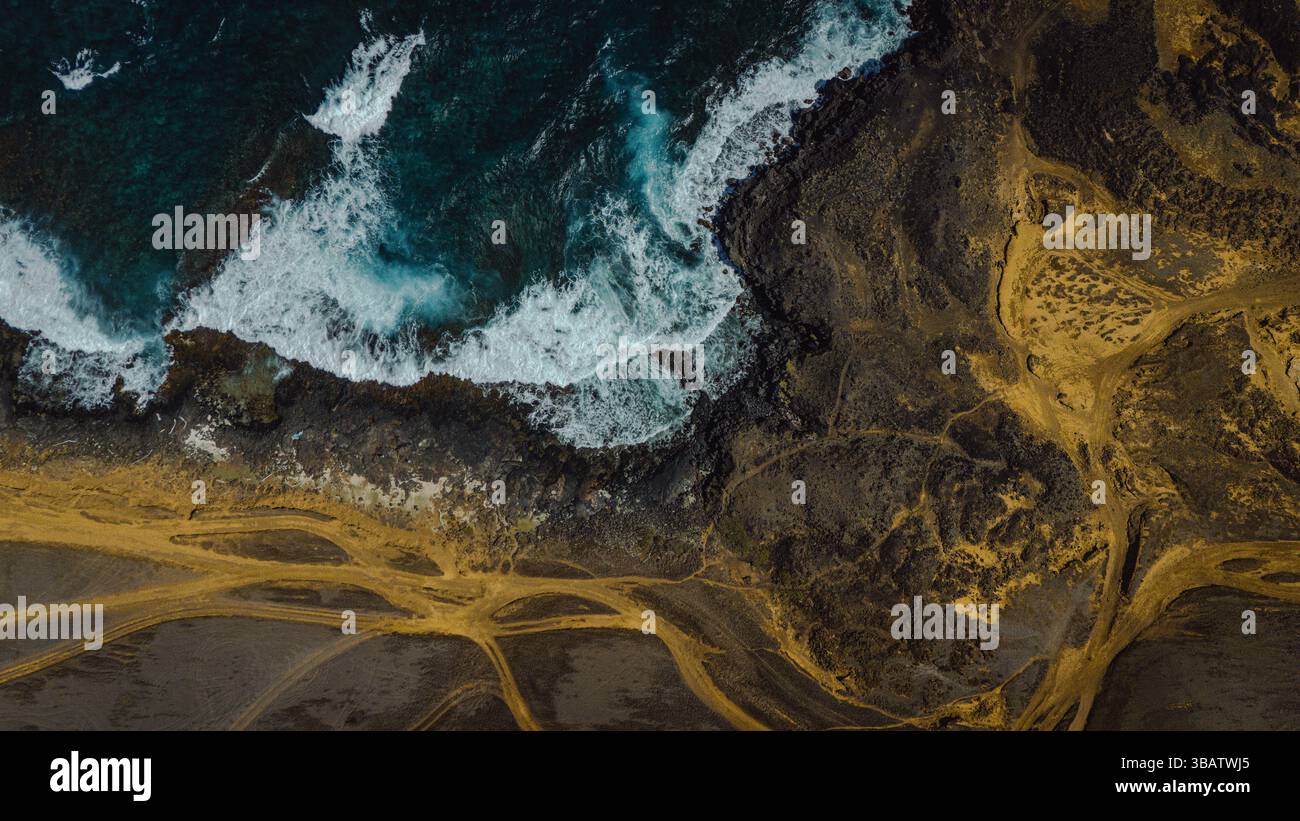 Aerial view of Green Sand Beach shoreline with turquoise waves and ...
