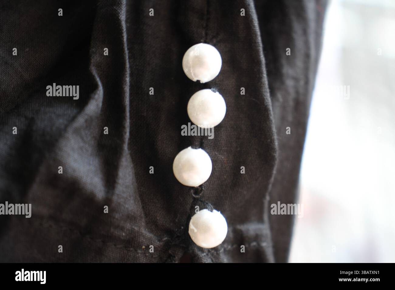 The four white balls are attached to a black cloth Stock Photo - Alamy
