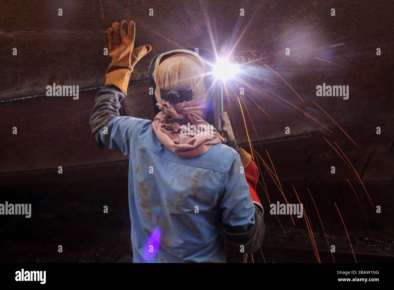 May 13, 2025, Dhaka, Dhaka, Bangladesh: A worker dismantles decommissioned vessels at a ...