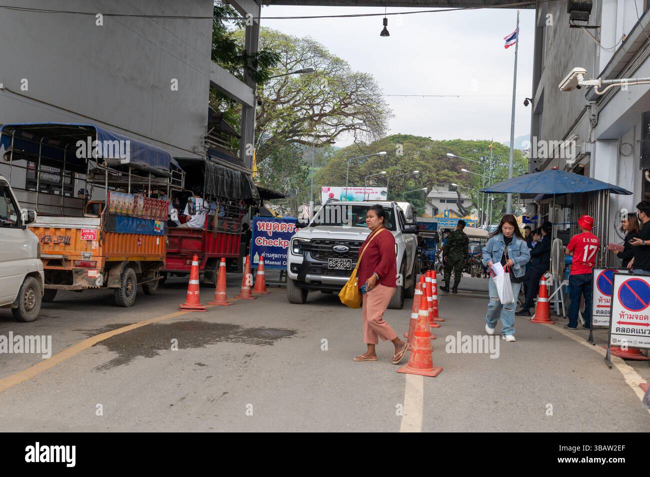 At the busy entrance of the main border crossing between Mae Sai in northern Thailand and ...
