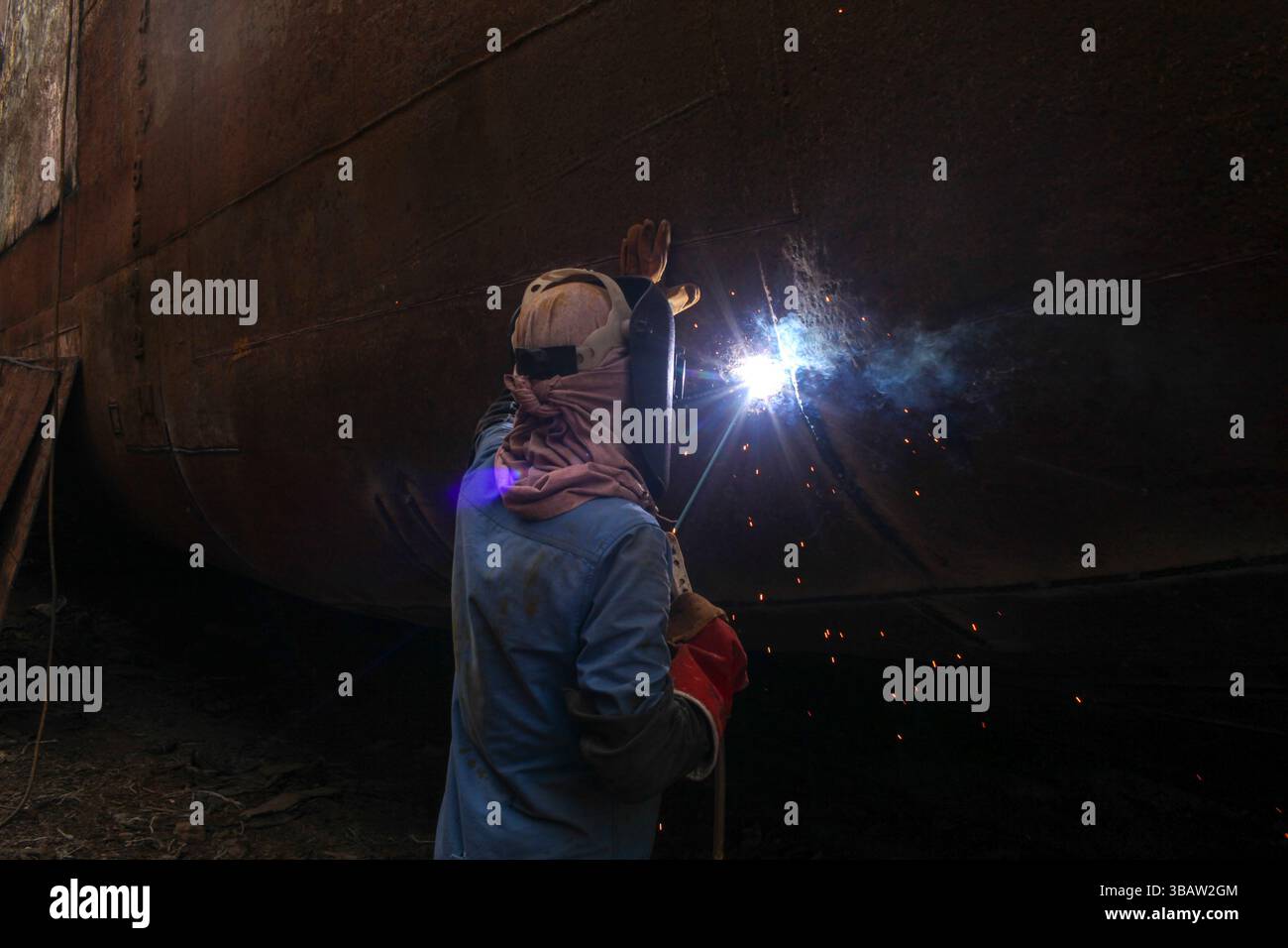 May 13, 2025, Dhaka, Dhaka, Bangladesh: A worker dismantles decommissioned vessels at a ...