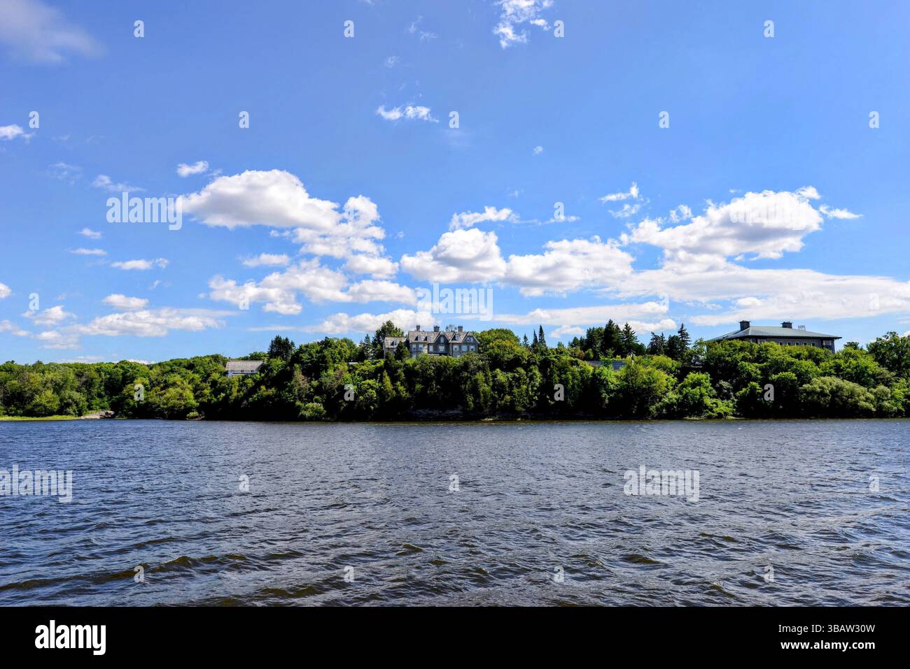 Elegant riverside mansions surrounded by lush greenery in Gatineau ...