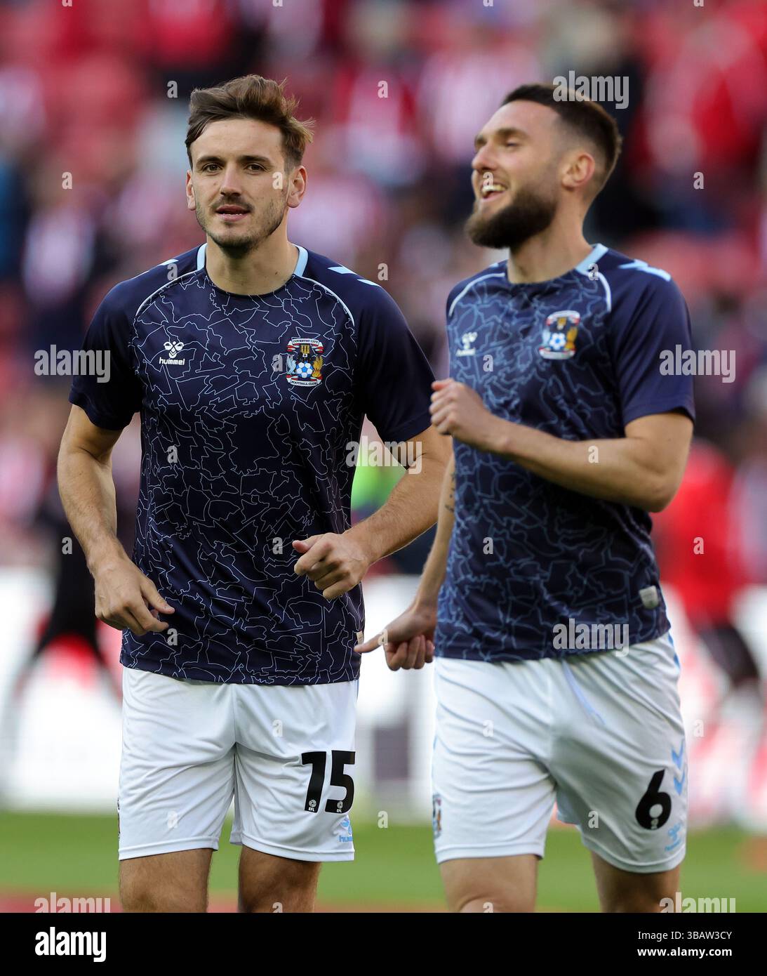 Coventry City's Liam Kitching and Matt Grimes (right) warm up before ...