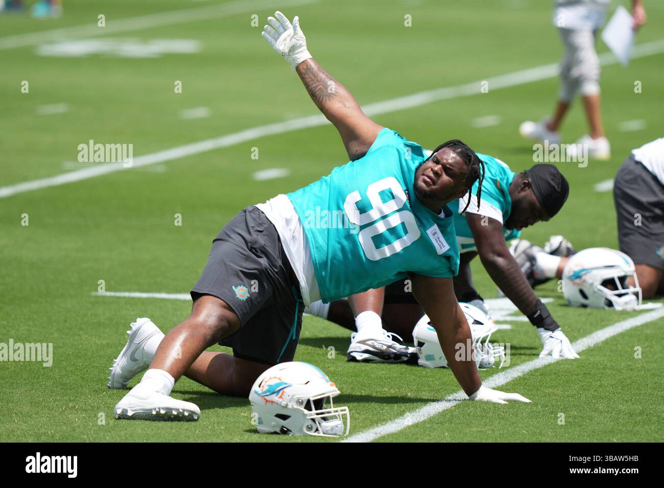 Miami Dolphins defensive tackle Kenneth Grant (90) stretches during the ...