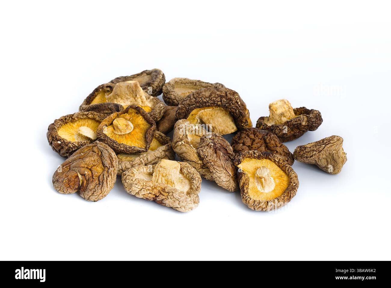 This vibrant image features dried shiitake mushrooms on white ...