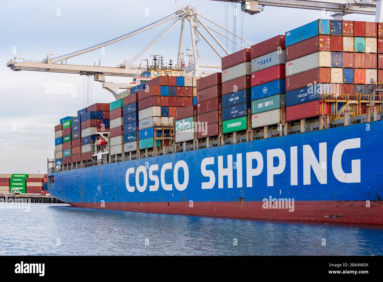 A large blue container ship "Cosco Shipping" with many shipping ...