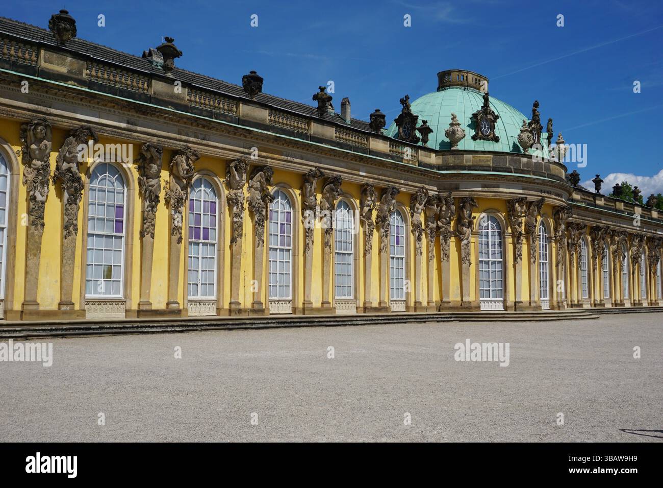 The ornate side facade and cupola of Sanssouci Palace, the landmark ...