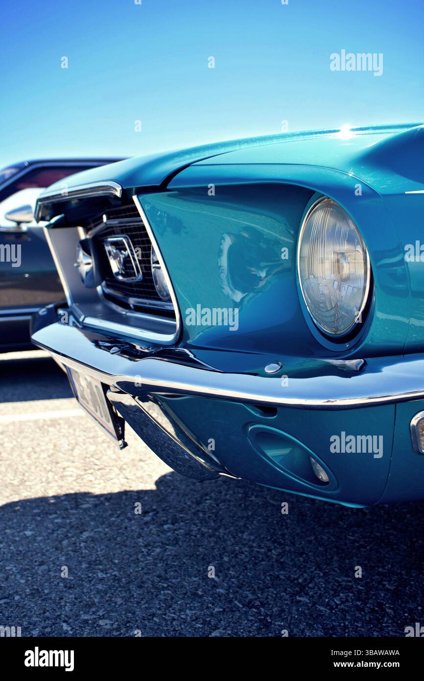 Front View of a Classic Blue Ford Mustang with Chrome Bumper and Iconic ...