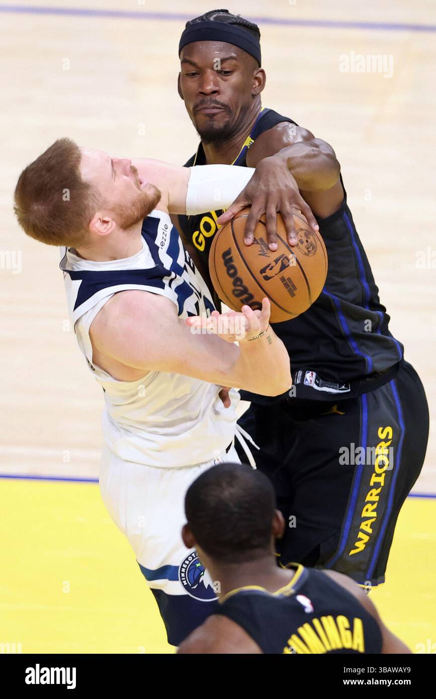 Golden State Warriors' Jimmy Butler III slips the ball away from Minnesota Timberwolves' Donte ...