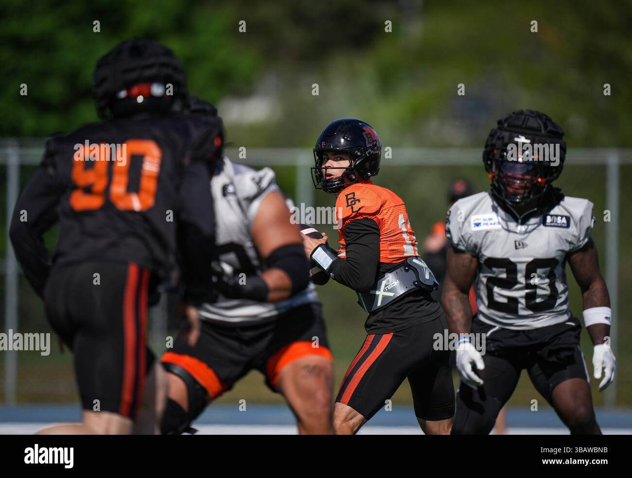 Kamloops, Canada. 13th May, 2025. B.C. Lions quarterback Nathan Rourke, back, looks to pass ...