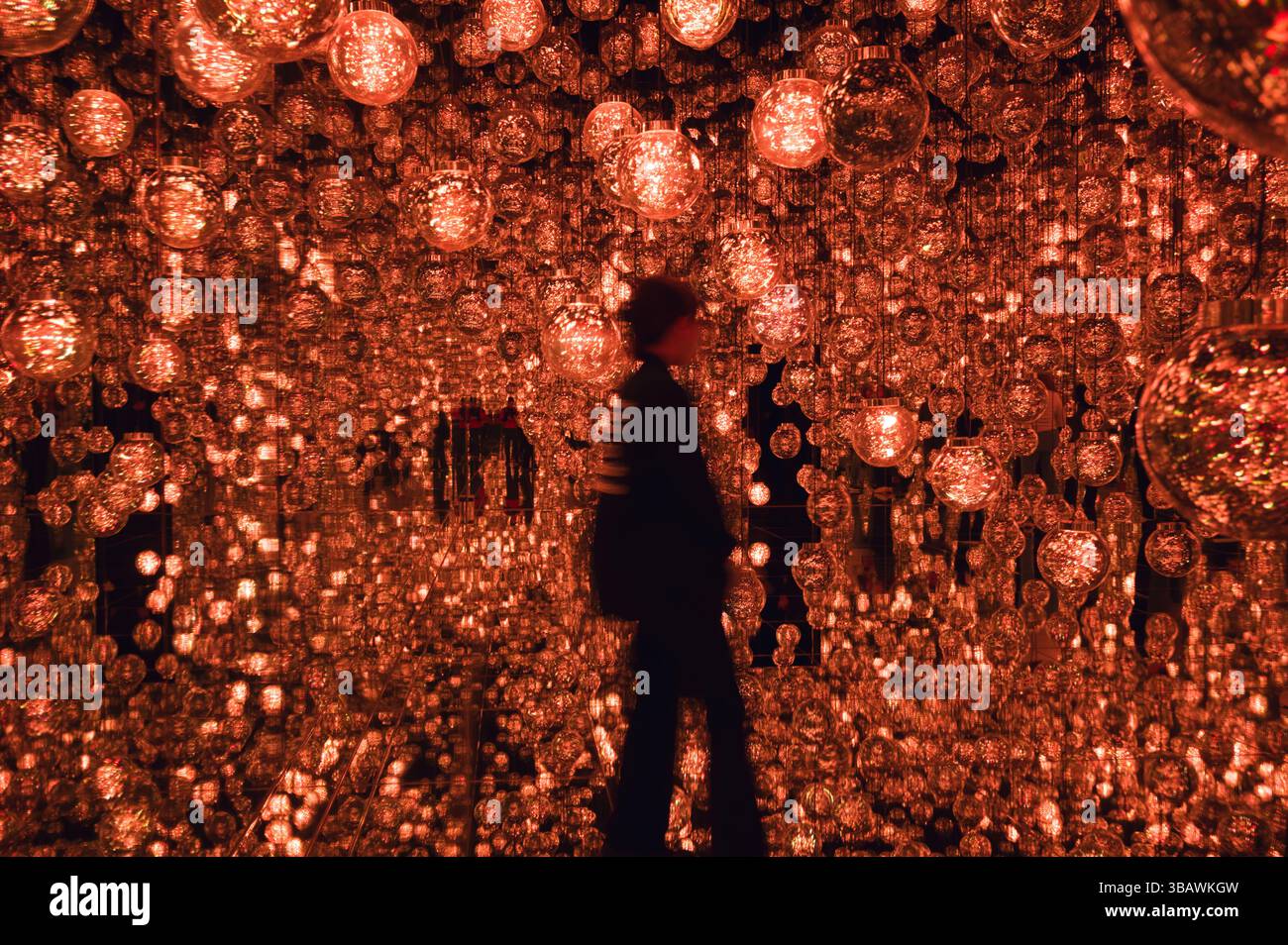 TeamLab Borderless staff tending the lights in a luminous maze of ...