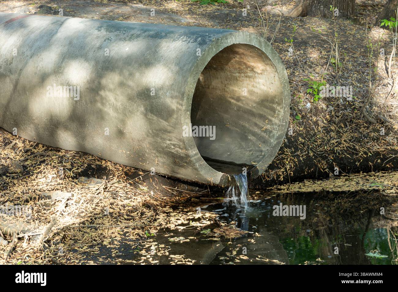Concrete pipe of the rubble from which water flows into nature. Waste ...