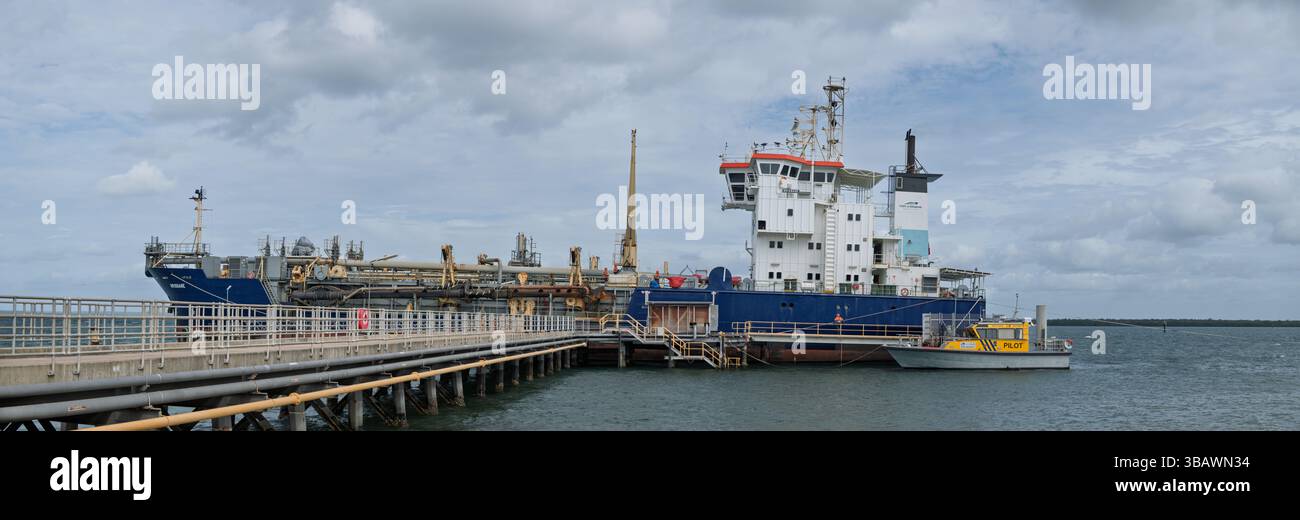 Port of Weipa, large cargo ship with smaller pilot vessel, high ...
