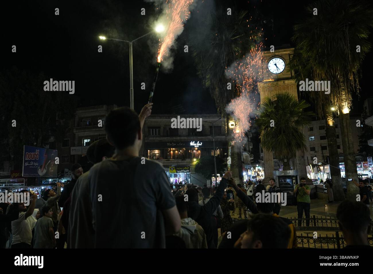 Idlib City, Syria. 13th May, 2025. Syrians set off fireworks during ...