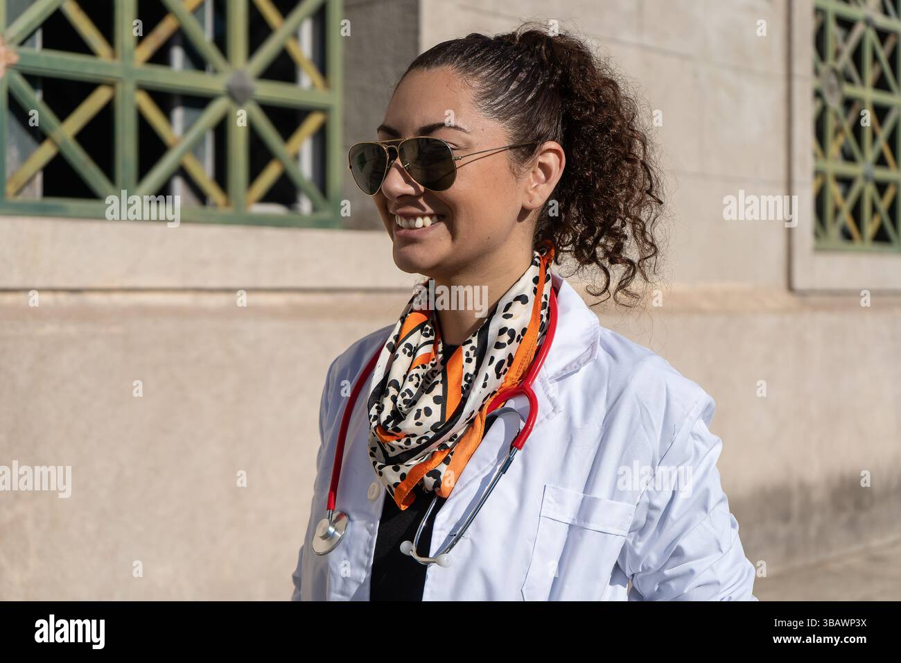 Female medical professional wearing sunglasses and a fashionable scarf ...