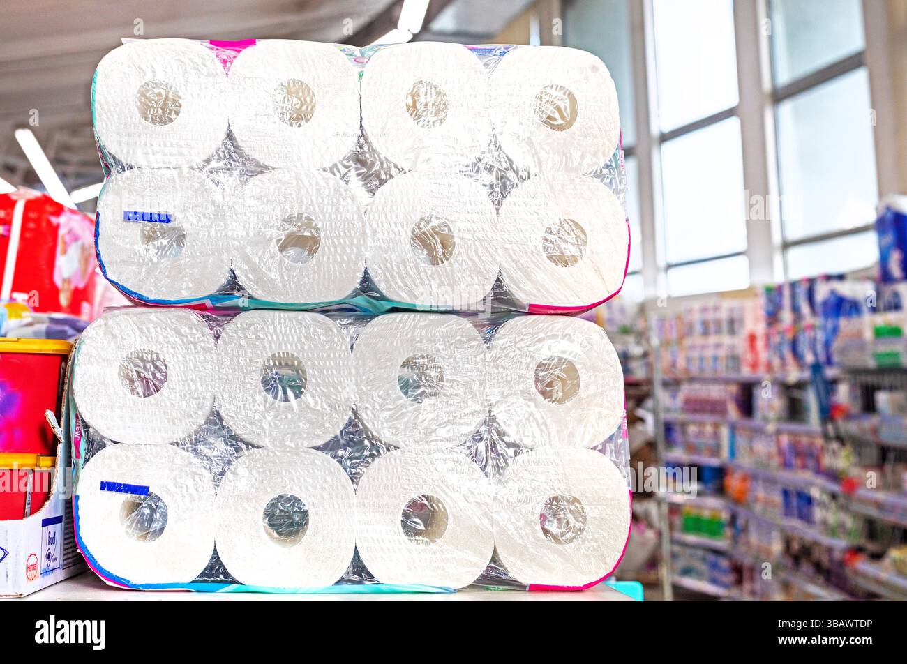 packaging toilet paper in transparent film in the supermarket ...