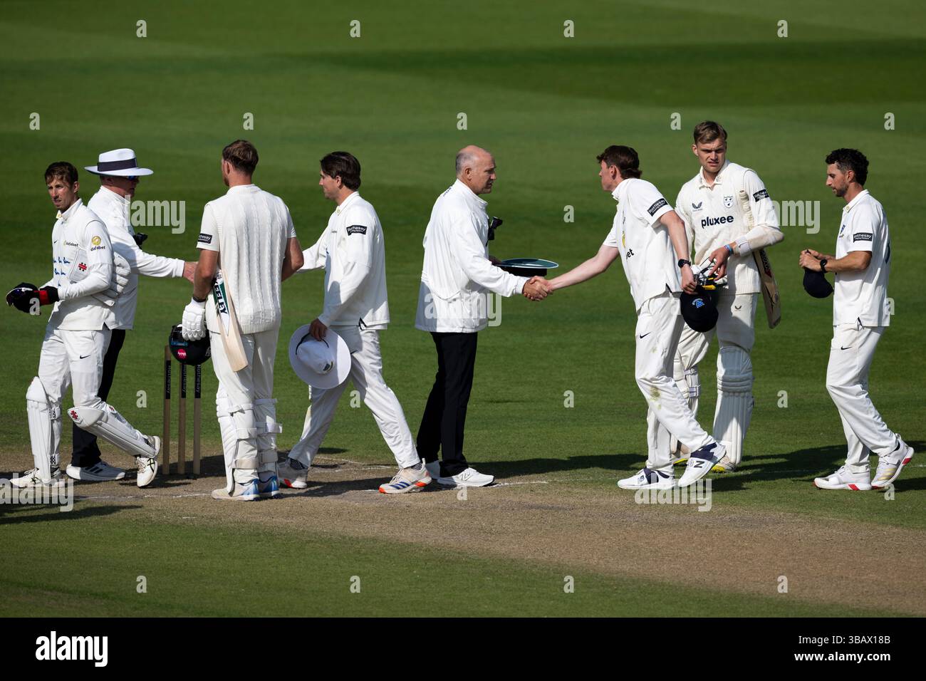 Cricket players shaking hands with umpires hi-res stock photography and ...