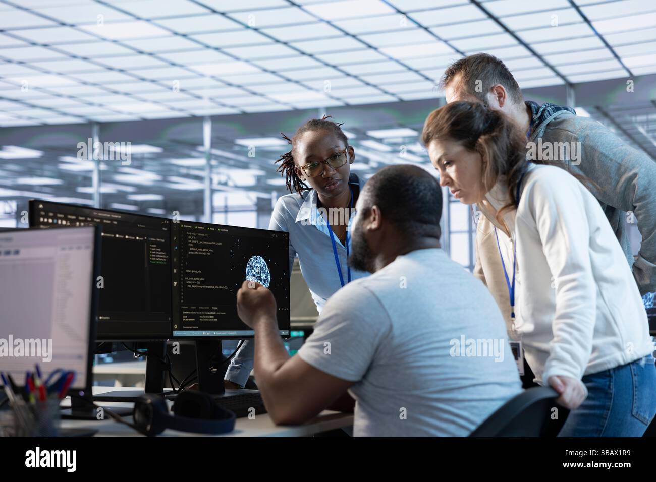 Team of engineers working in server farm, using PCs to analyze data. Multiracial group of ...
